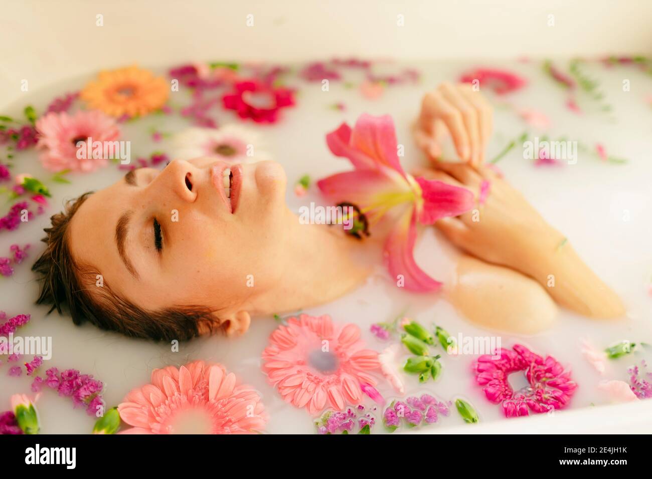 Beautiful woman taking milkbath in bathroom Stock Photo - Alamy