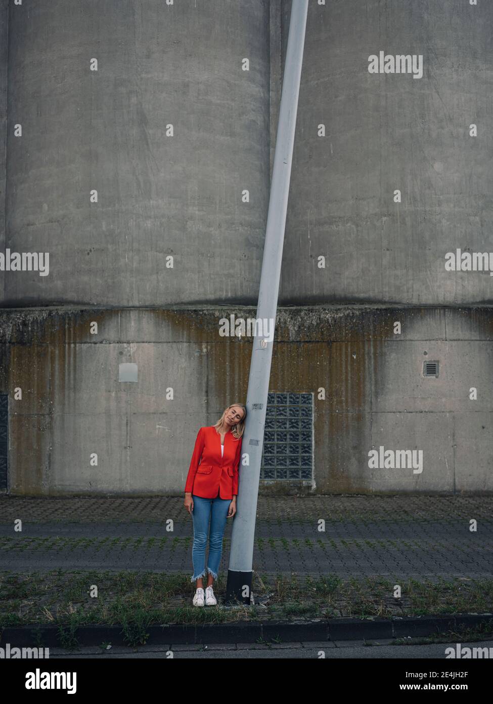 Woman leaning against pole on hi-res stock photography and images - Alamy