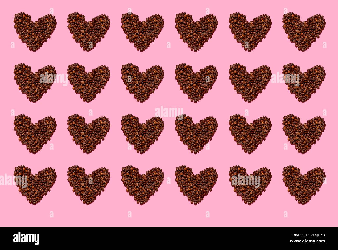 Pattern of roasted coffee beans arranged into heart shapes Stock Photo ...