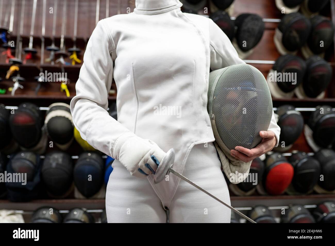 Woman in fencing outfit standing at gym Stock Photo - Alamy