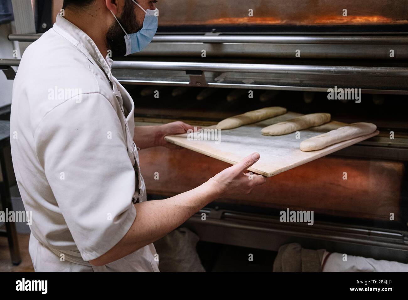 Putting bread in oven hi-res stock photography and images - Alamy