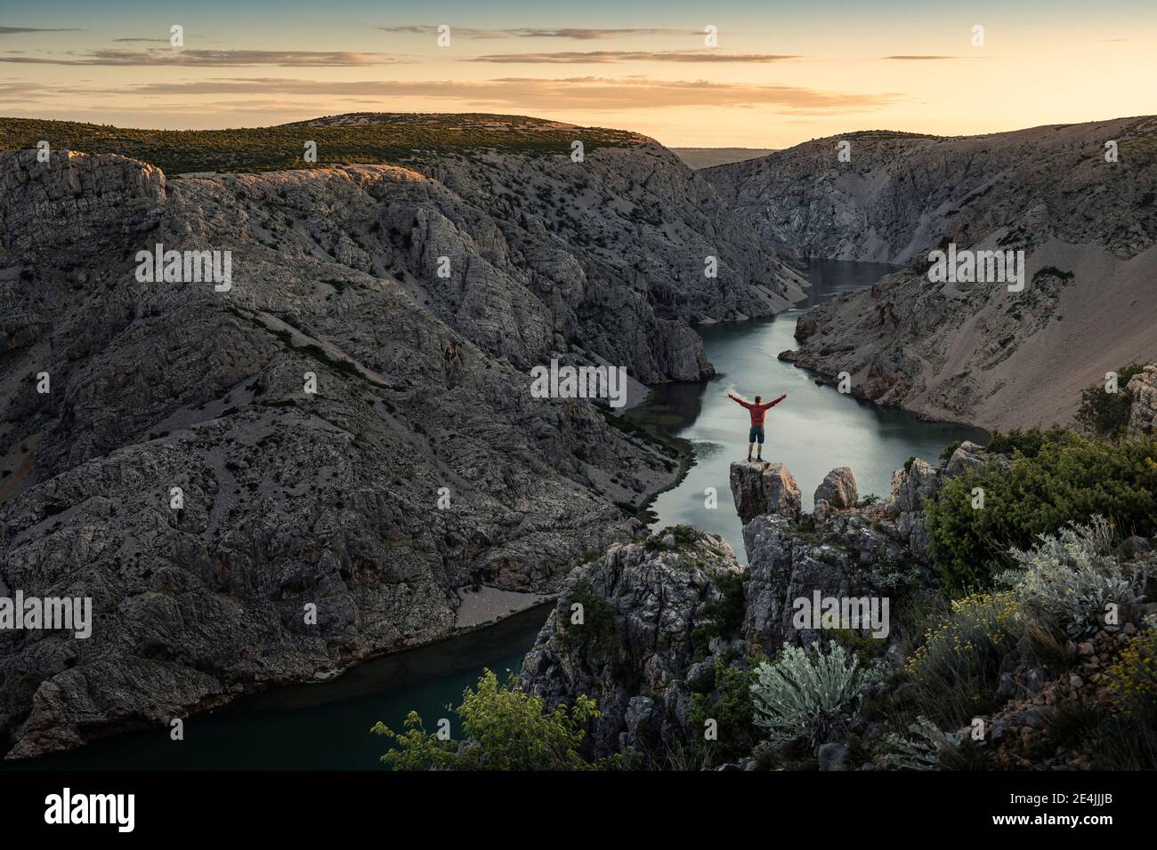 Man standing rock sunset looking view hi-res stock photography and ...