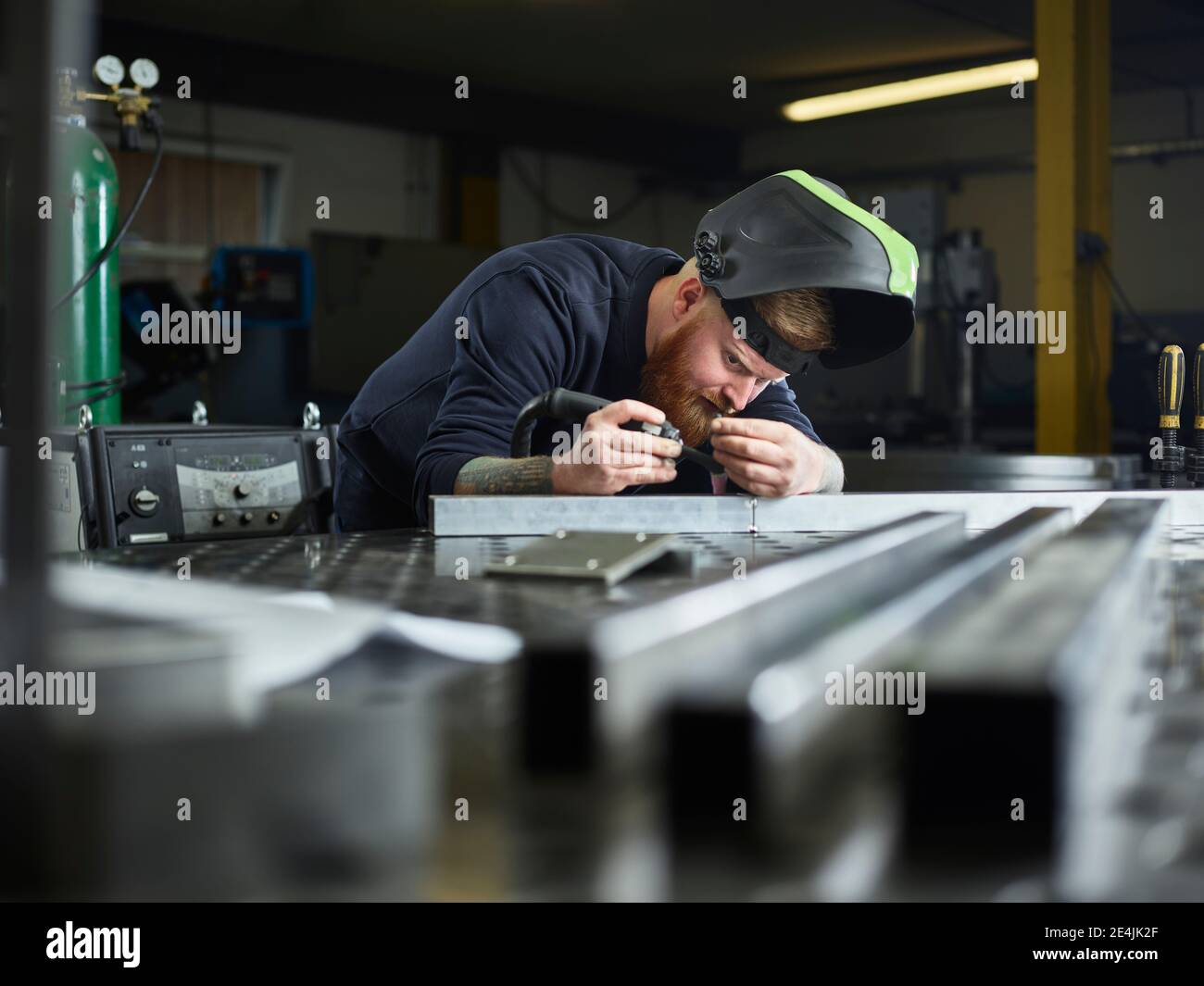 Metal technician examining material while working at factory Stock ...