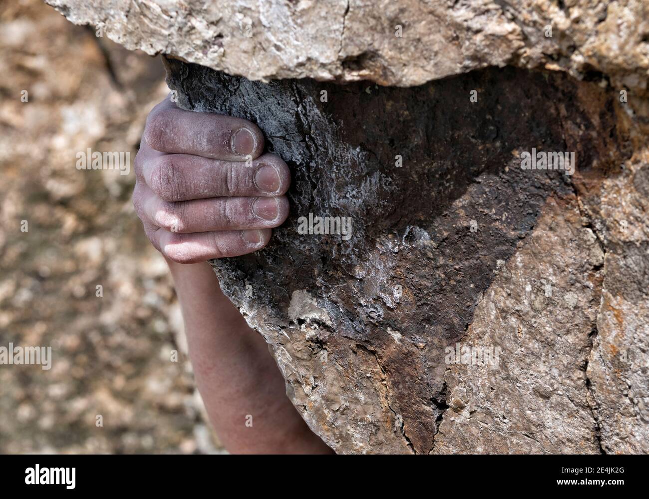 Hand of young man climbing boulder Stock Photo - Alamy