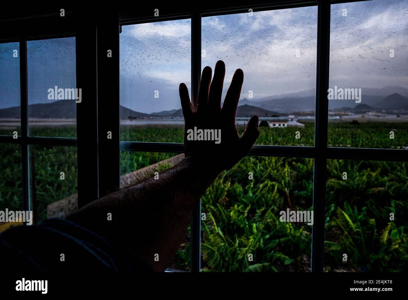 Silhouette man looking through window hi-res stock photography and ...