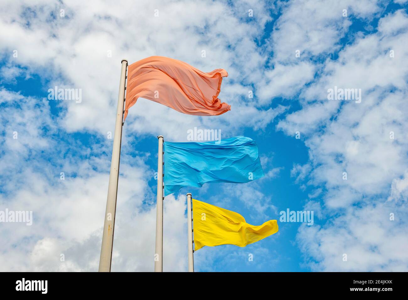 Red, blue and yellow flag in front of cloudy sky, Berlin, Germany Stock ...