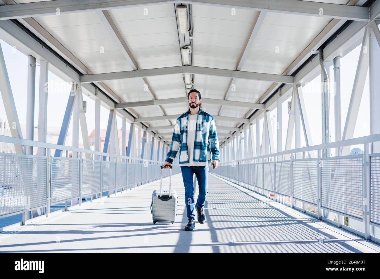 Pulling man on luggage hi-res stock photography and images - Alamy