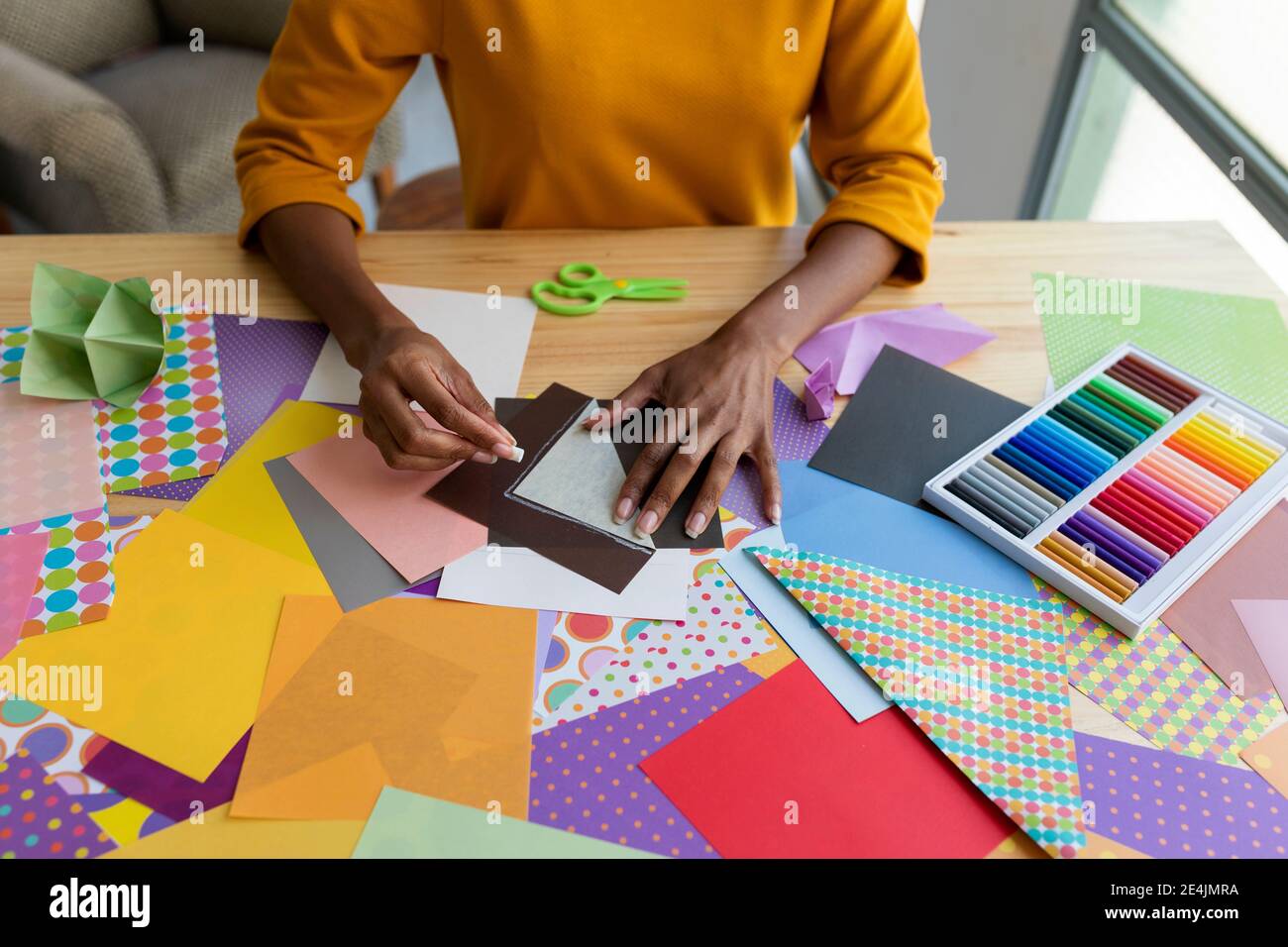 Origami artist sitting in studio folding colorful paper Stock Photo - Alamy