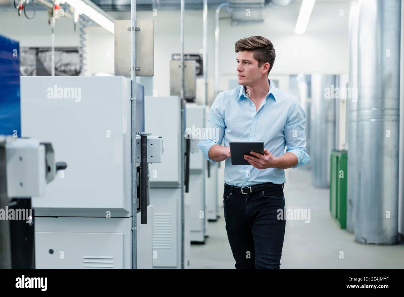 Businessman walking looking around holding hi-res stock photography and ...