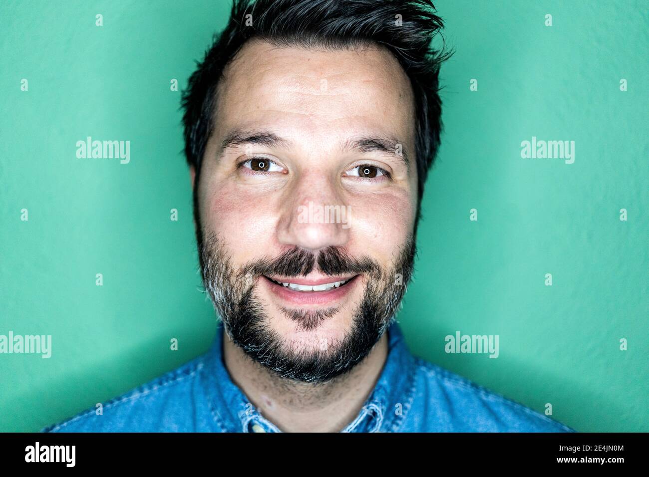Studio portrait of smiling man Stock Photo - Alamy