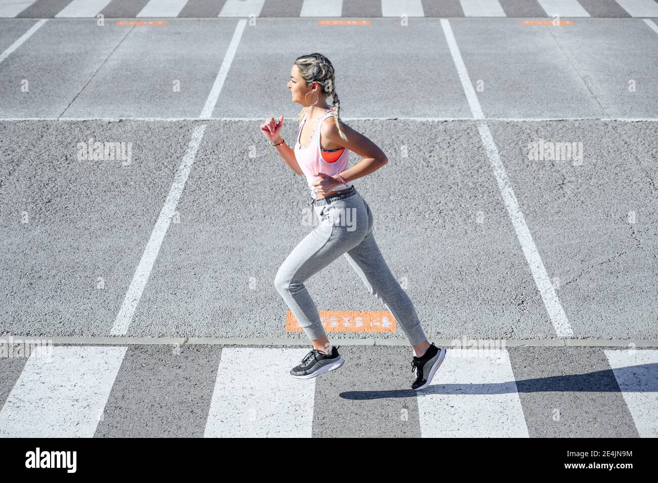 Athlete practicing while running on road Stock Photo - Alamy