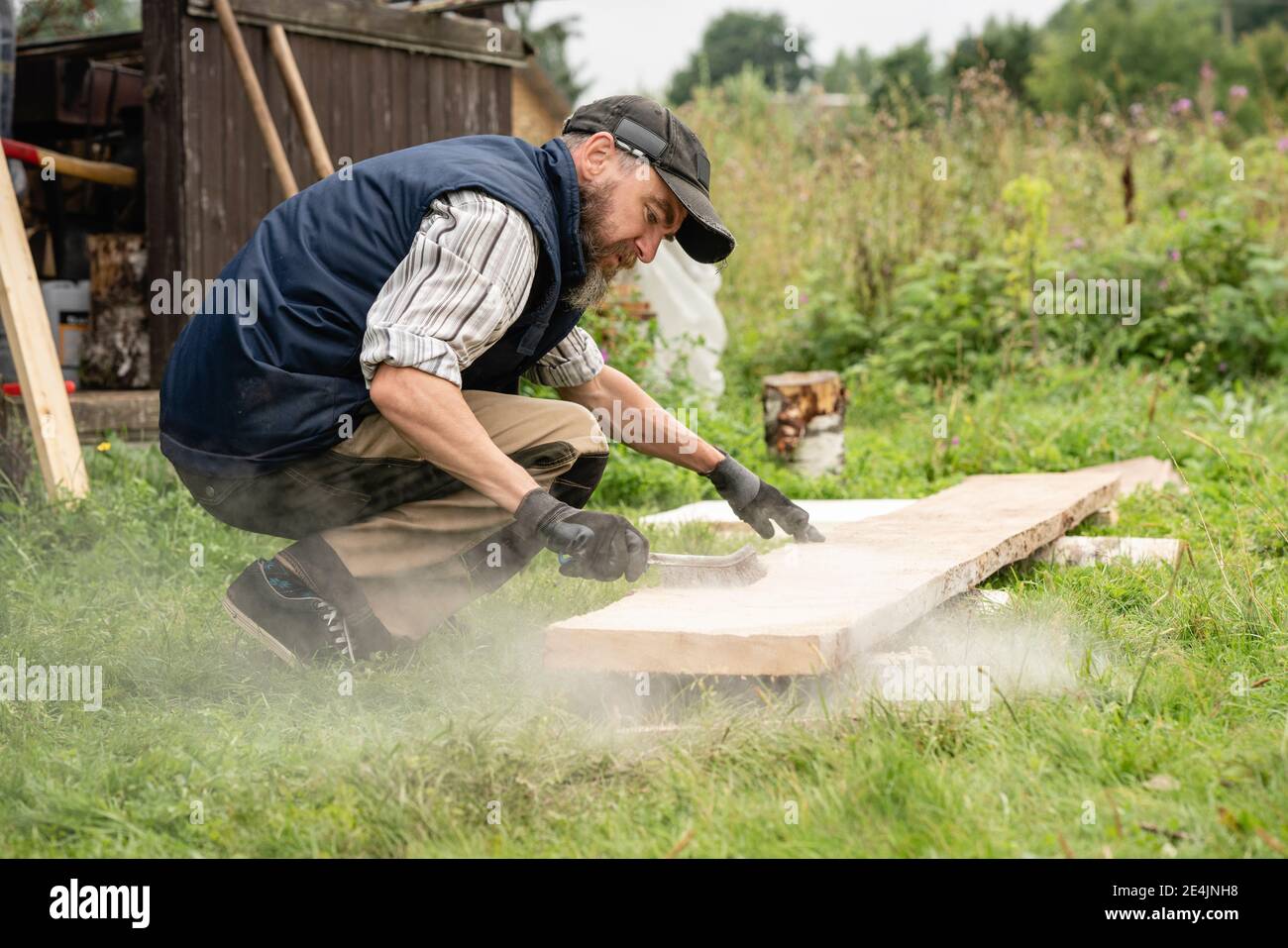 Carpenter brushing plank with wire brush Stock Photo - Alamy