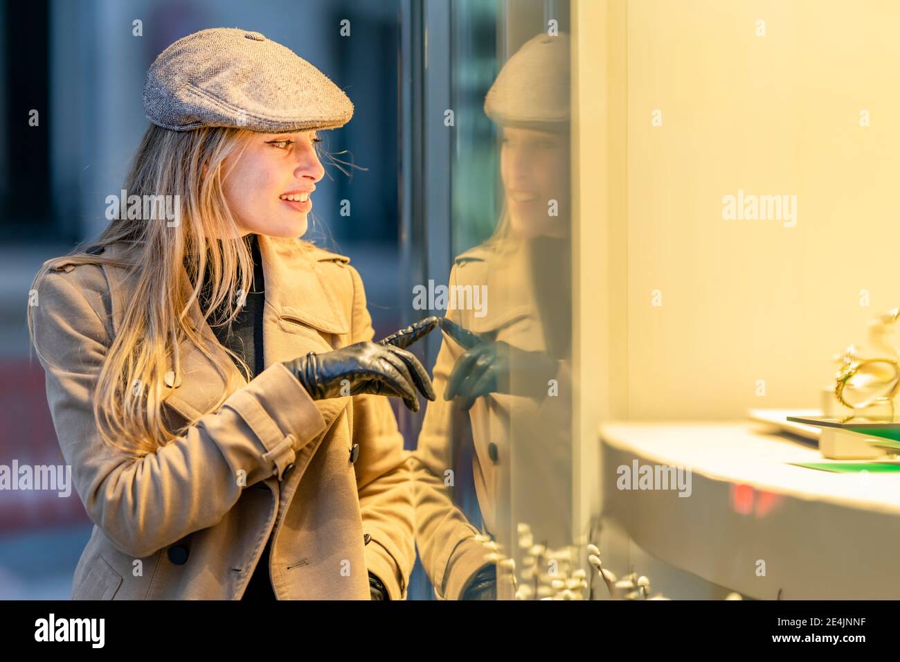 Beautiful woman doing window shopping at night Stock Photo - Alamy
