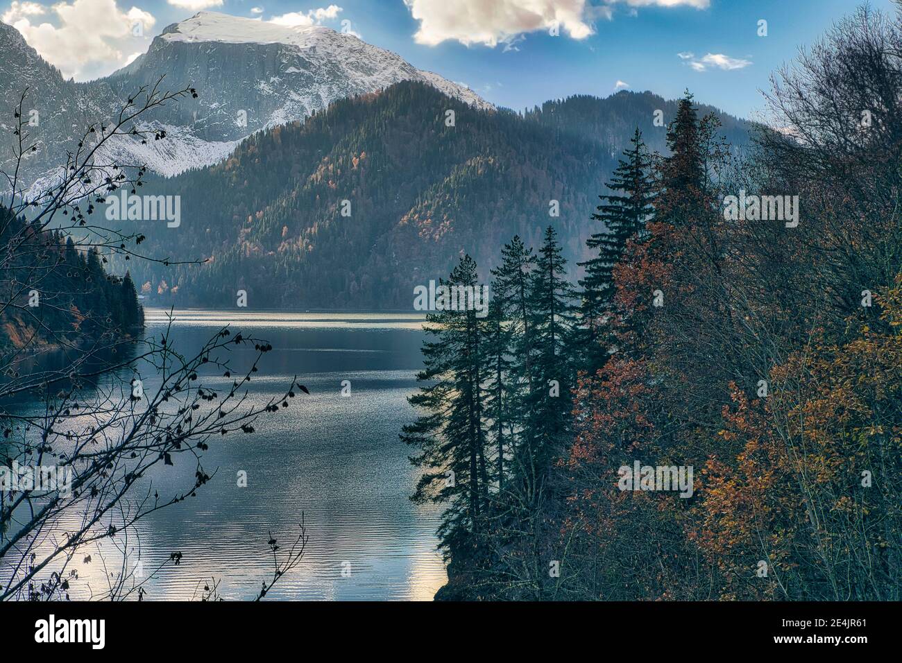 Lake Ritsa surrounded by forested mountains in autumn, Abkhazia ...