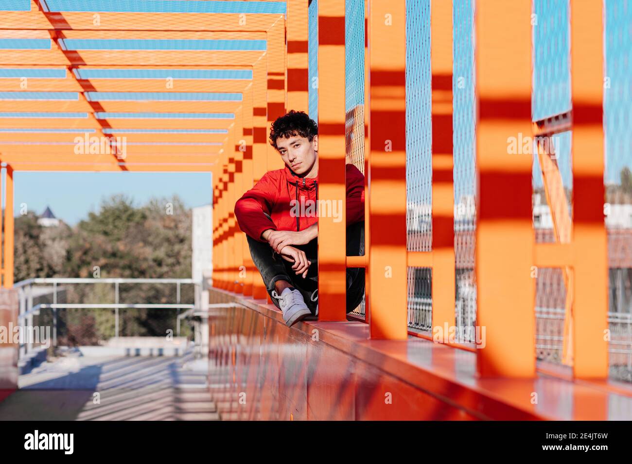 Portrait man sitting on railing hi-res stock photography and images - Alamy