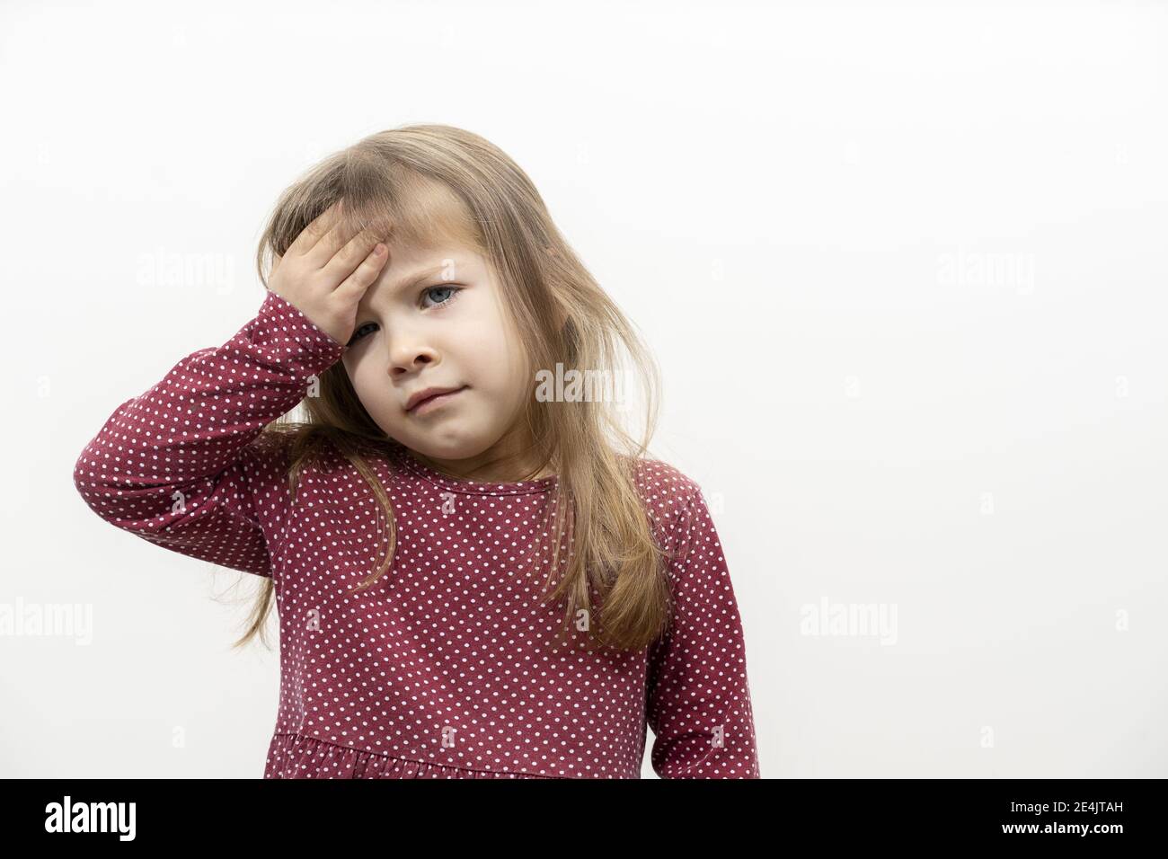 children's emotions. the little girl has a headache. the child holds on ...