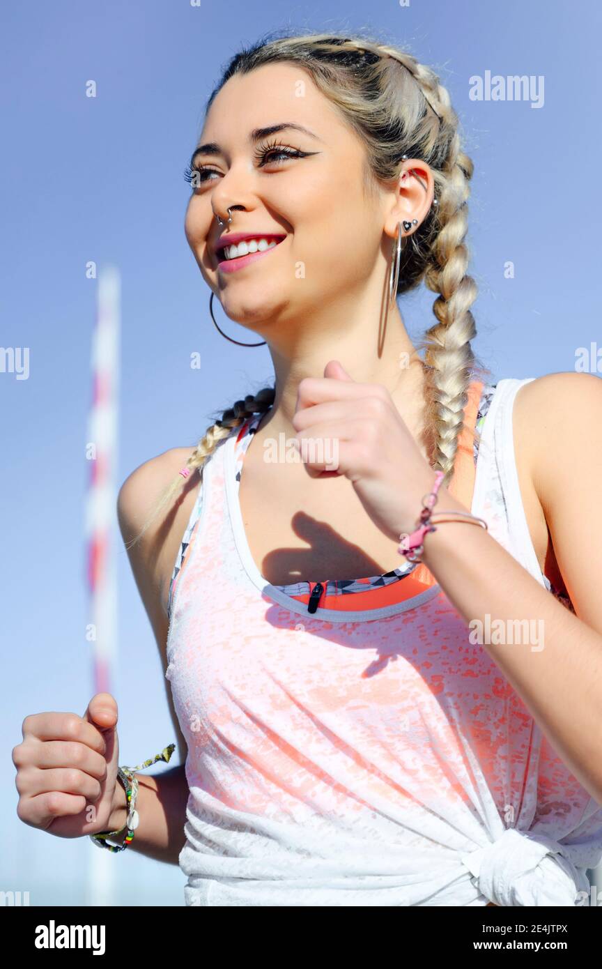 Athlete smiling while exercising outdoors Stock Photo - Alamy