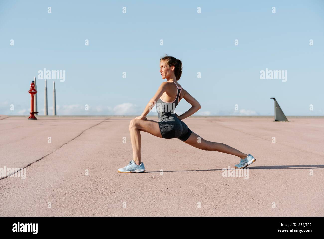 Female sportsperson doing stretching exercise on a sunny day Stock ...