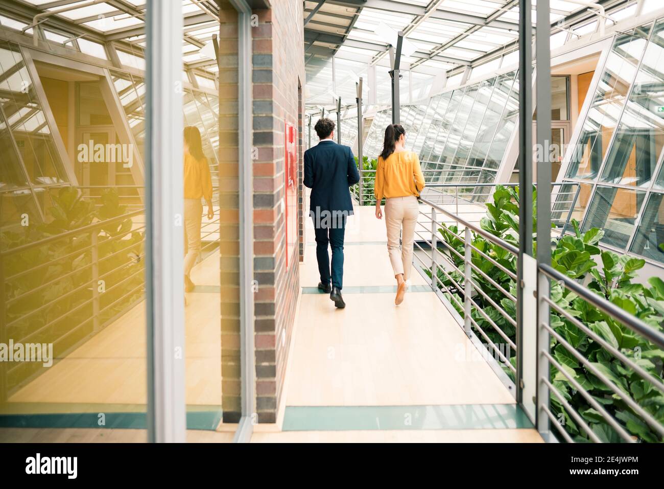 Walking in office atrium hi-res stock photography and images - Alamy