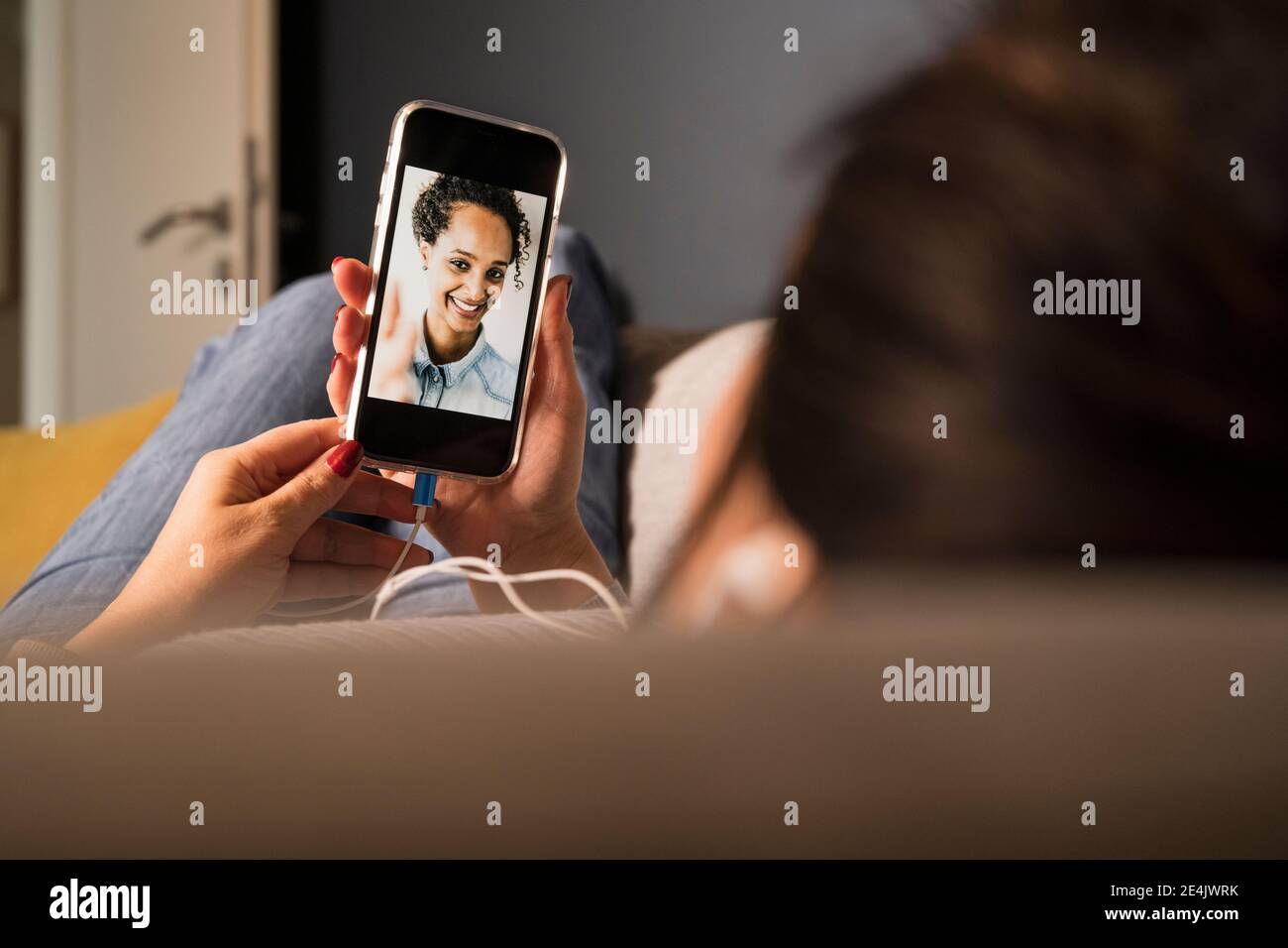 Multi ethnic female friends on video call through mobile phone Stock ...