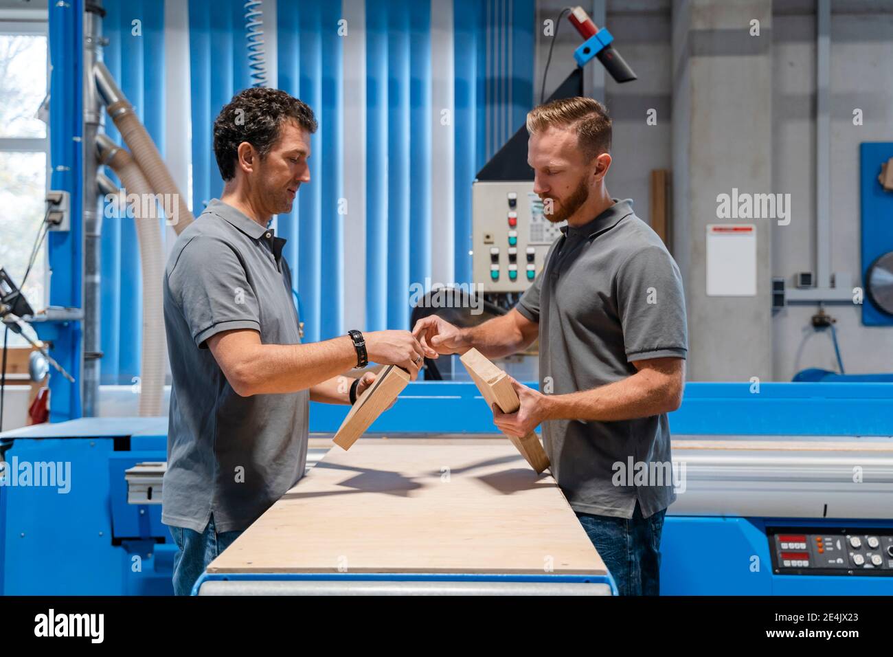 Two male carpenters talking in production hall Stock Photo - Alamy