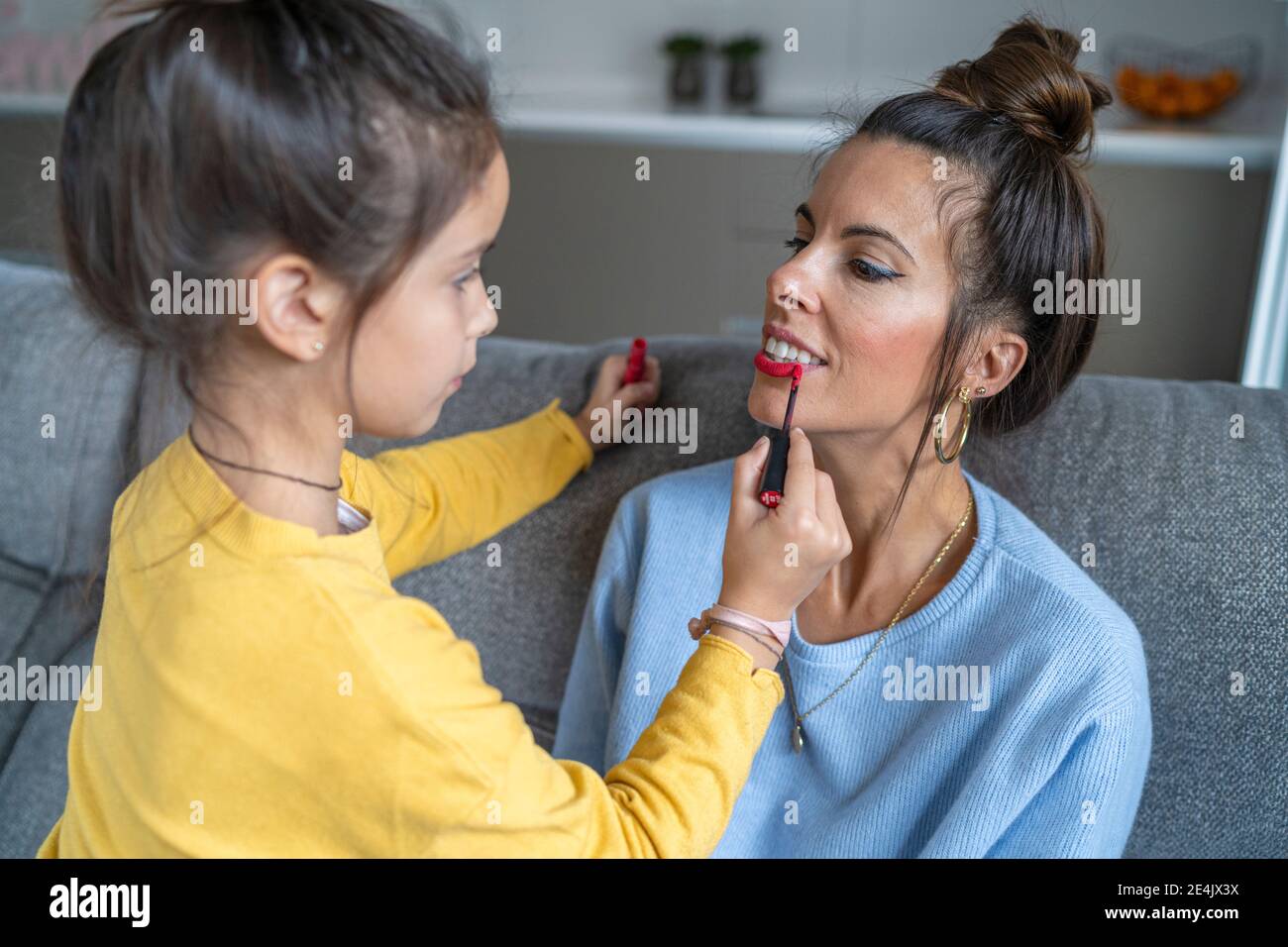 Mature woman applying lipstick in hi-res stock photography and images ...