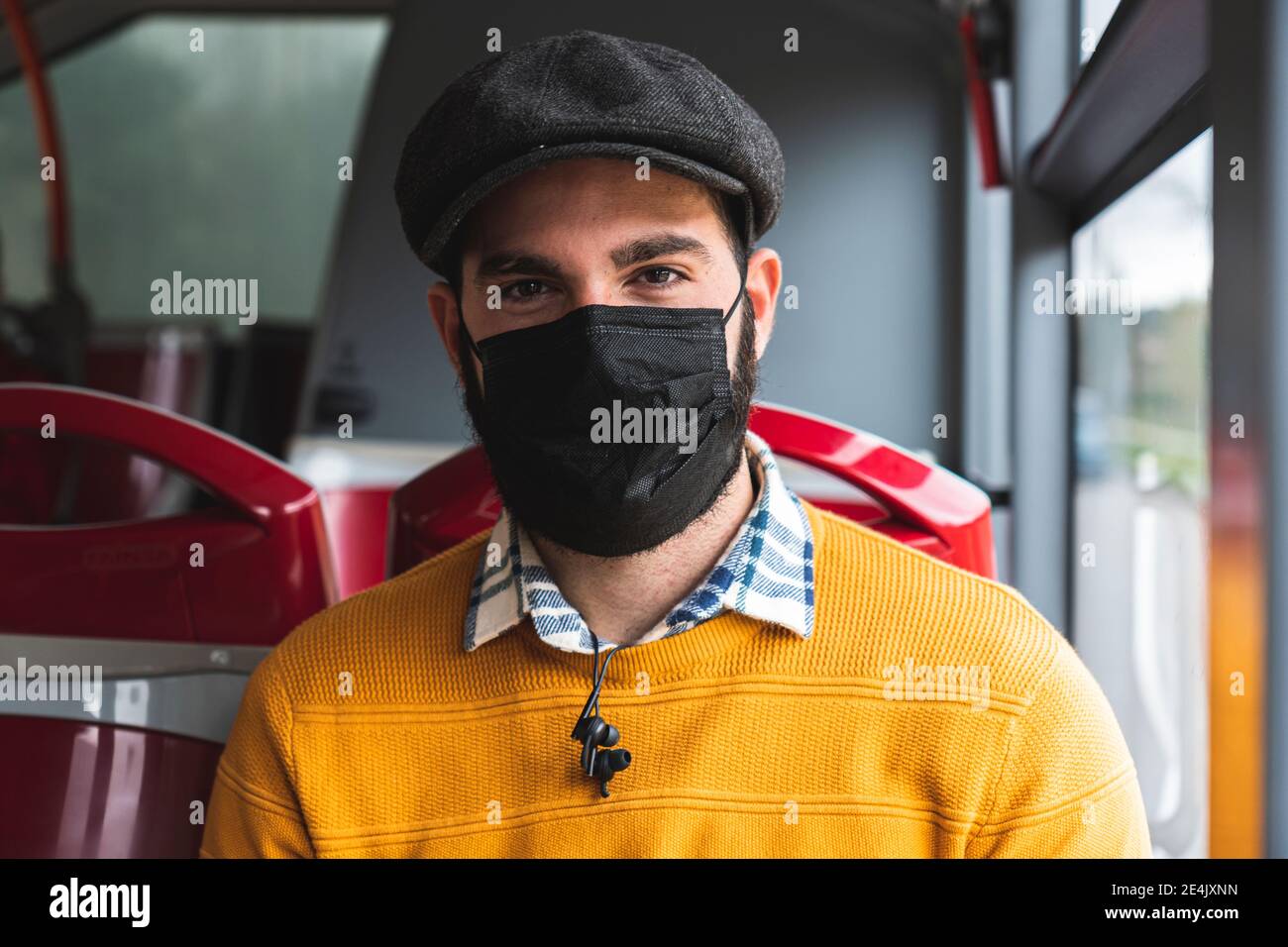Commuter in cap commuting in bus during COVID-19 Stock Photo - Alamy