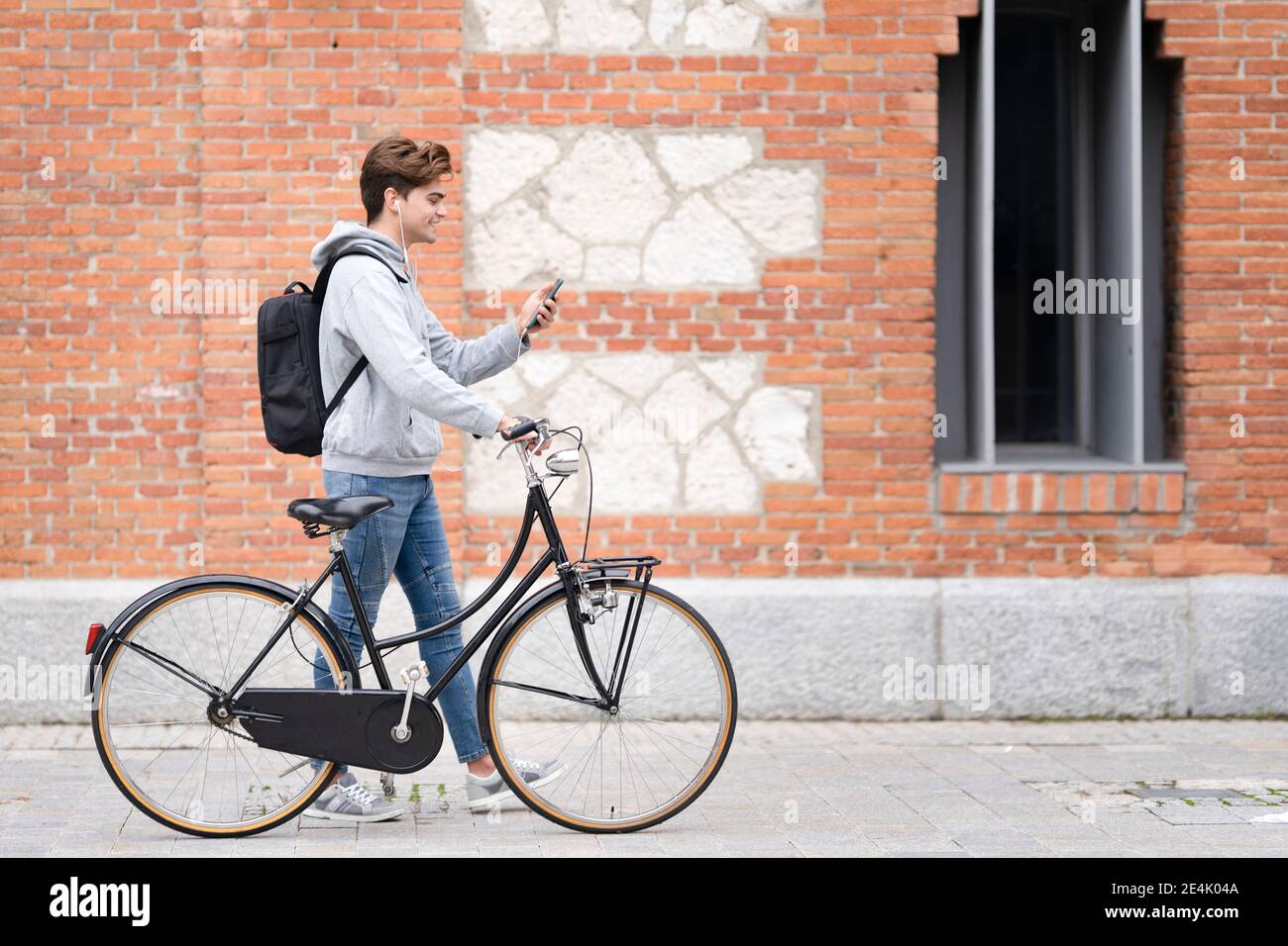 Man wheeling bike hi-res stock photography and images - Alamy