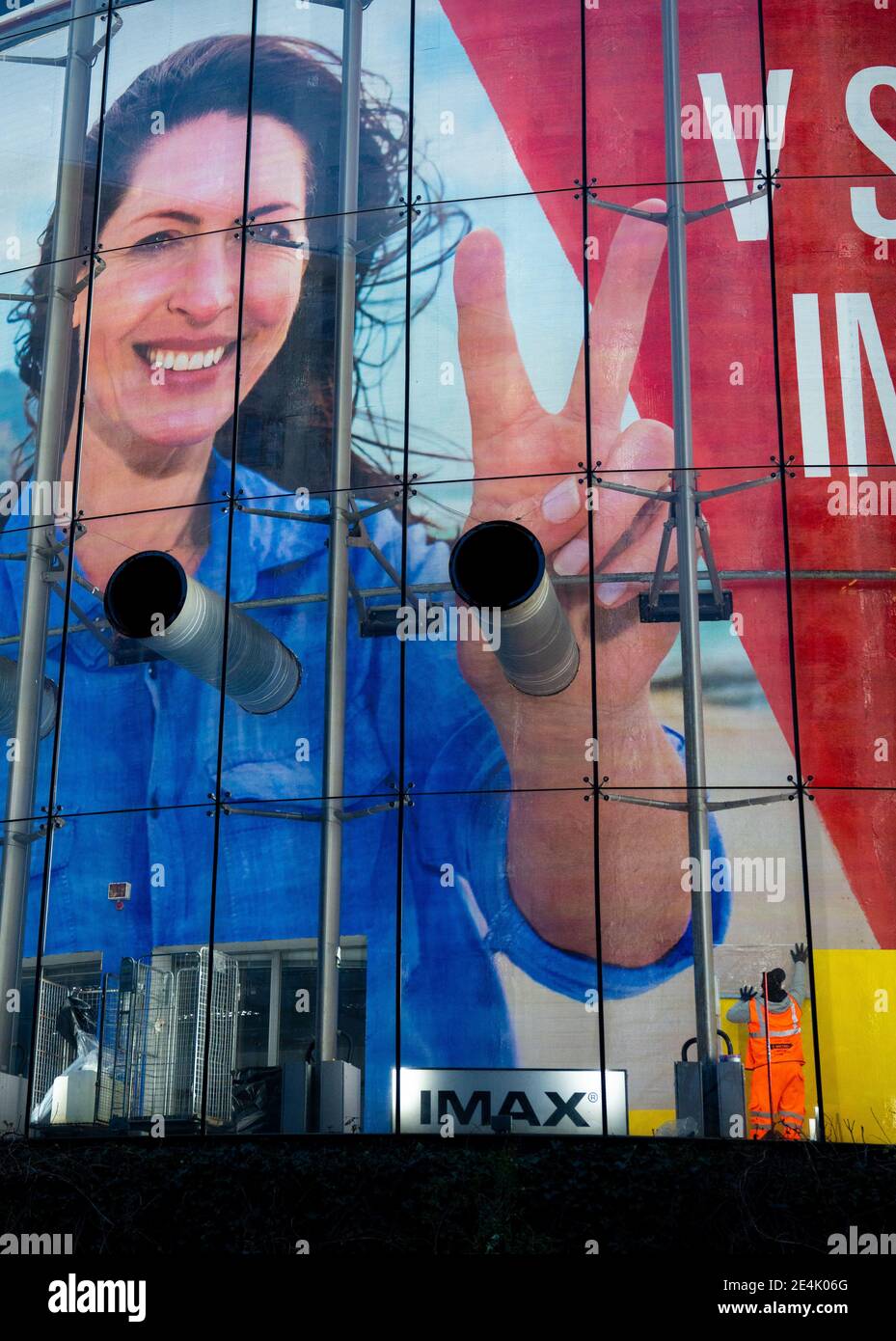 Workers change the large scale billboard advert on the outside of the ...