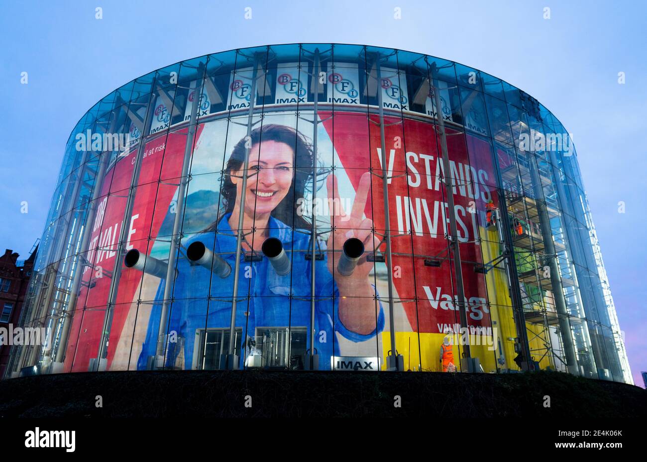 Workers change the large scale billboard advert on the outside of the ...