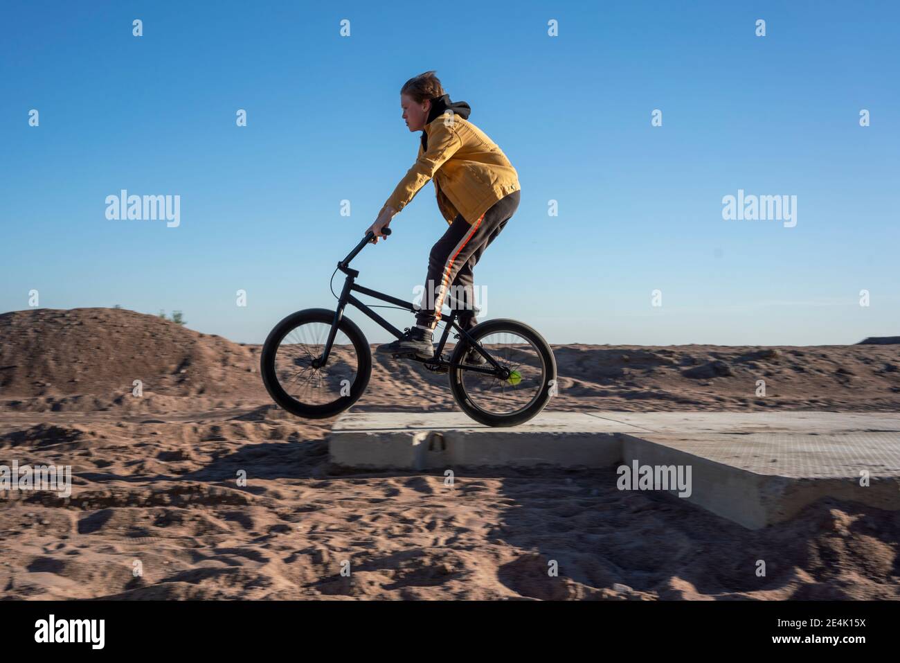 Boy riding BMX on sand Stock Photo - Alamy