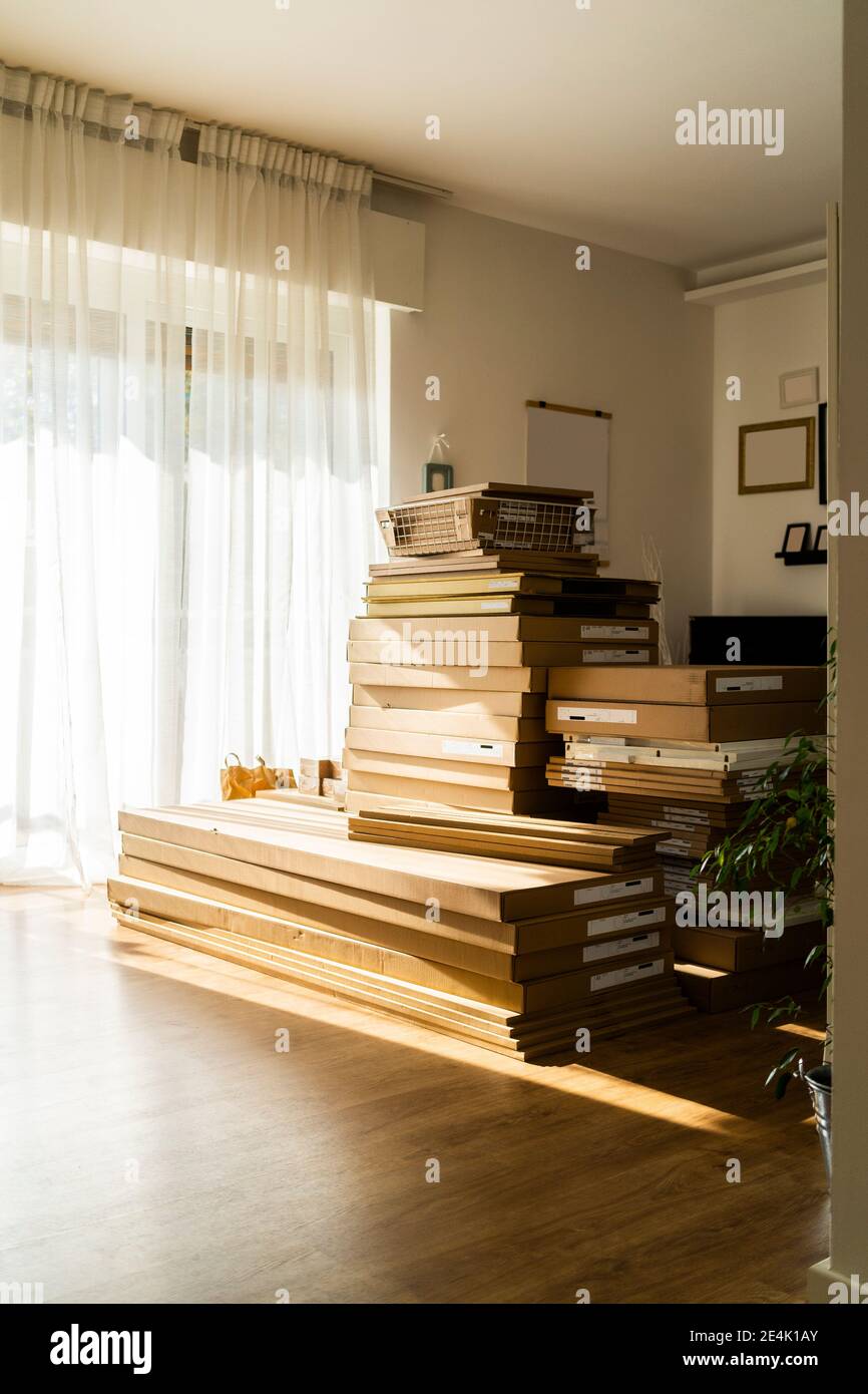 Stack of carton boxes in living room Stock Photo - Alamy