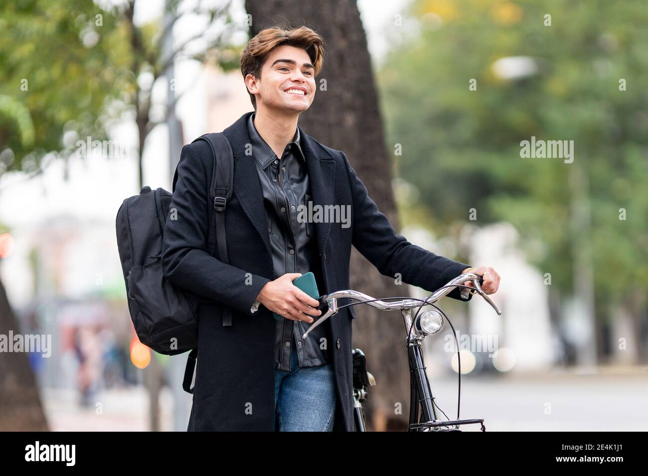 Man wheeling bike hi-res stock photography and images - Alamy