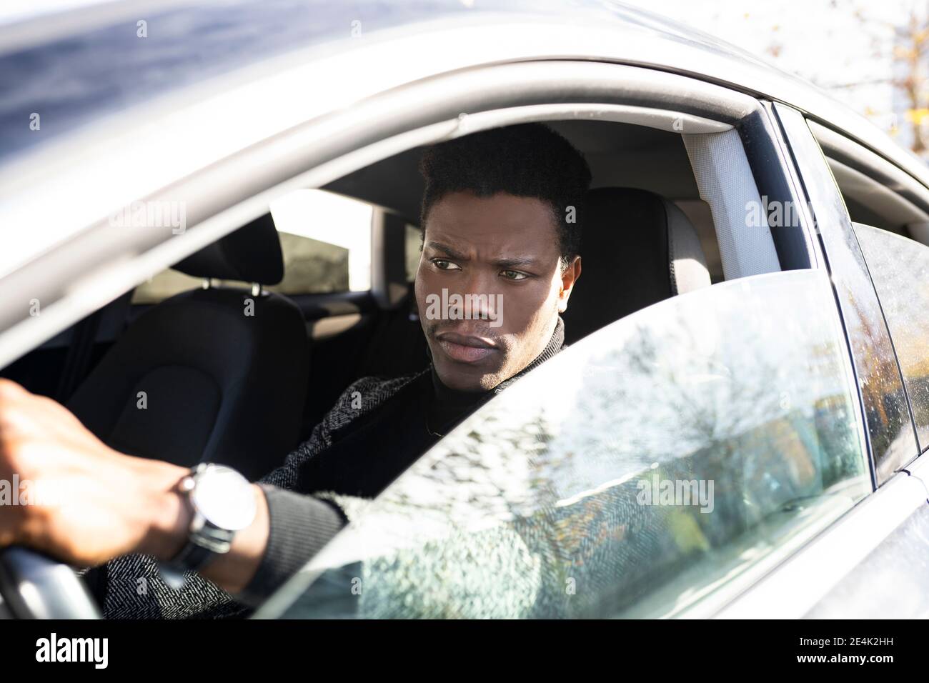 Young man driving car Stock Photo - Alamy