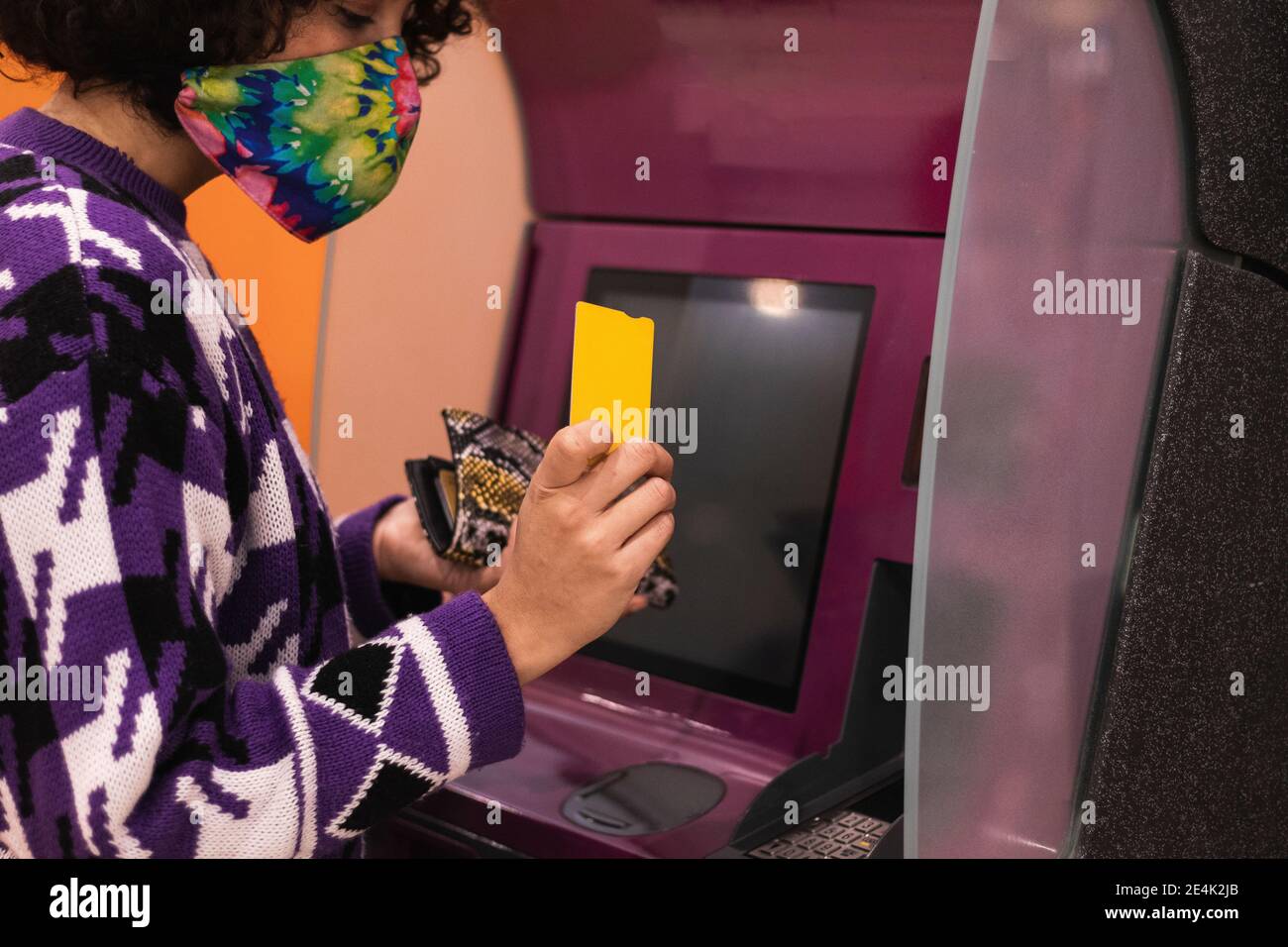 Young woman wearing face mask using credit card at ATM Stock Photo - Alamy