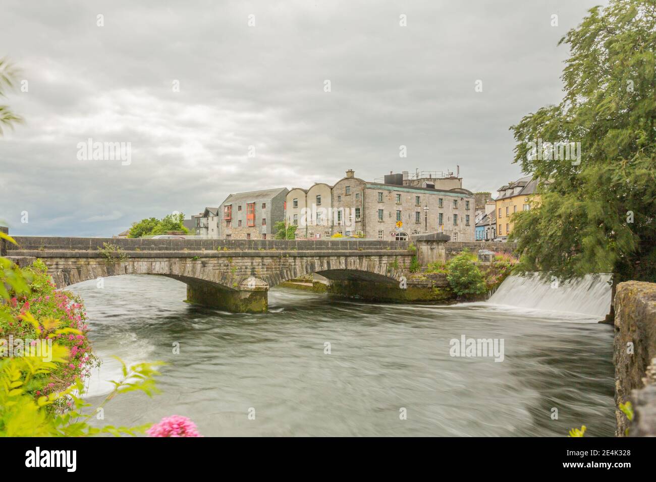 William O'Brien stone bridge over the Corrib river with flowing water ...