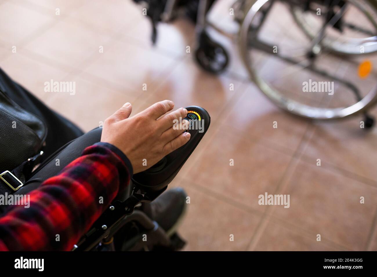 Disabled man's hand on button of motorized wheelchair Stock Photo - Alamy
