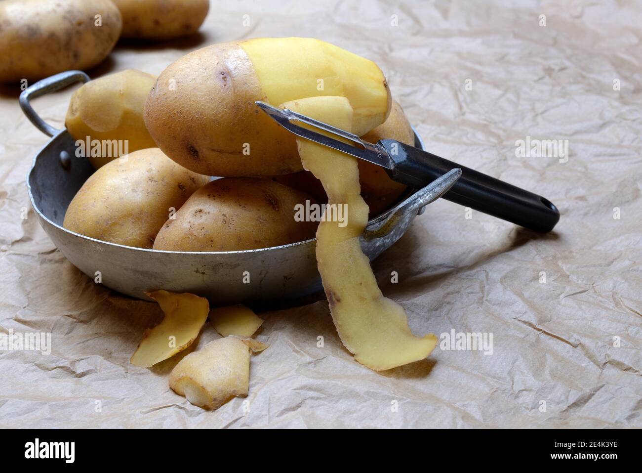 Potato peeling with peeler, Solanum tuberosum, potato peel, potato peel ...
