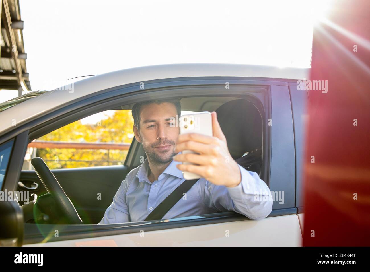 Handsome man looking out the window of the car hi-res stock photography ...