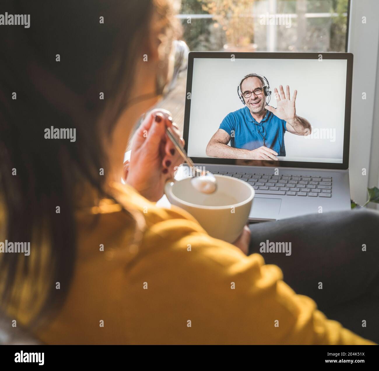 Man waving on screen during video call on laptop Stock Photo - Alamy