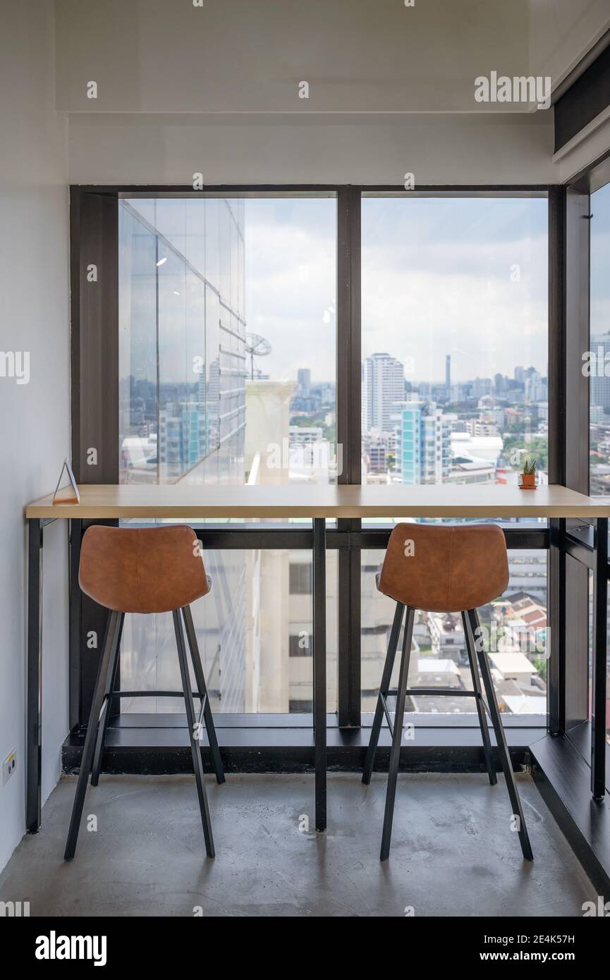 Wooden desk with chairs at corner modern office in downtown Stock Photo ...