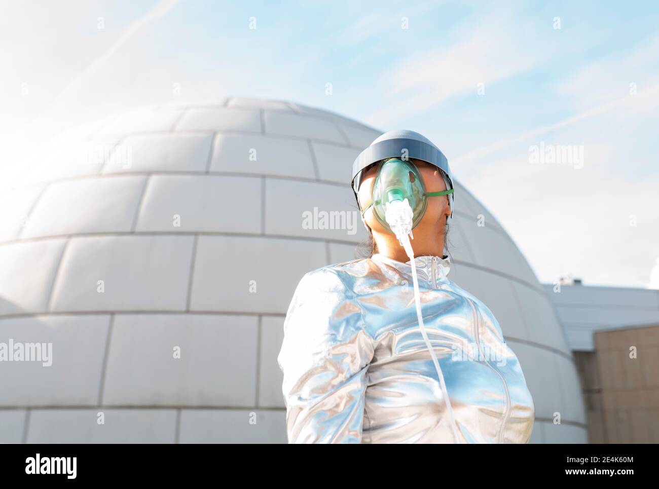 Woman wearing futuristic sunglasses and oxygen mask standing against ...