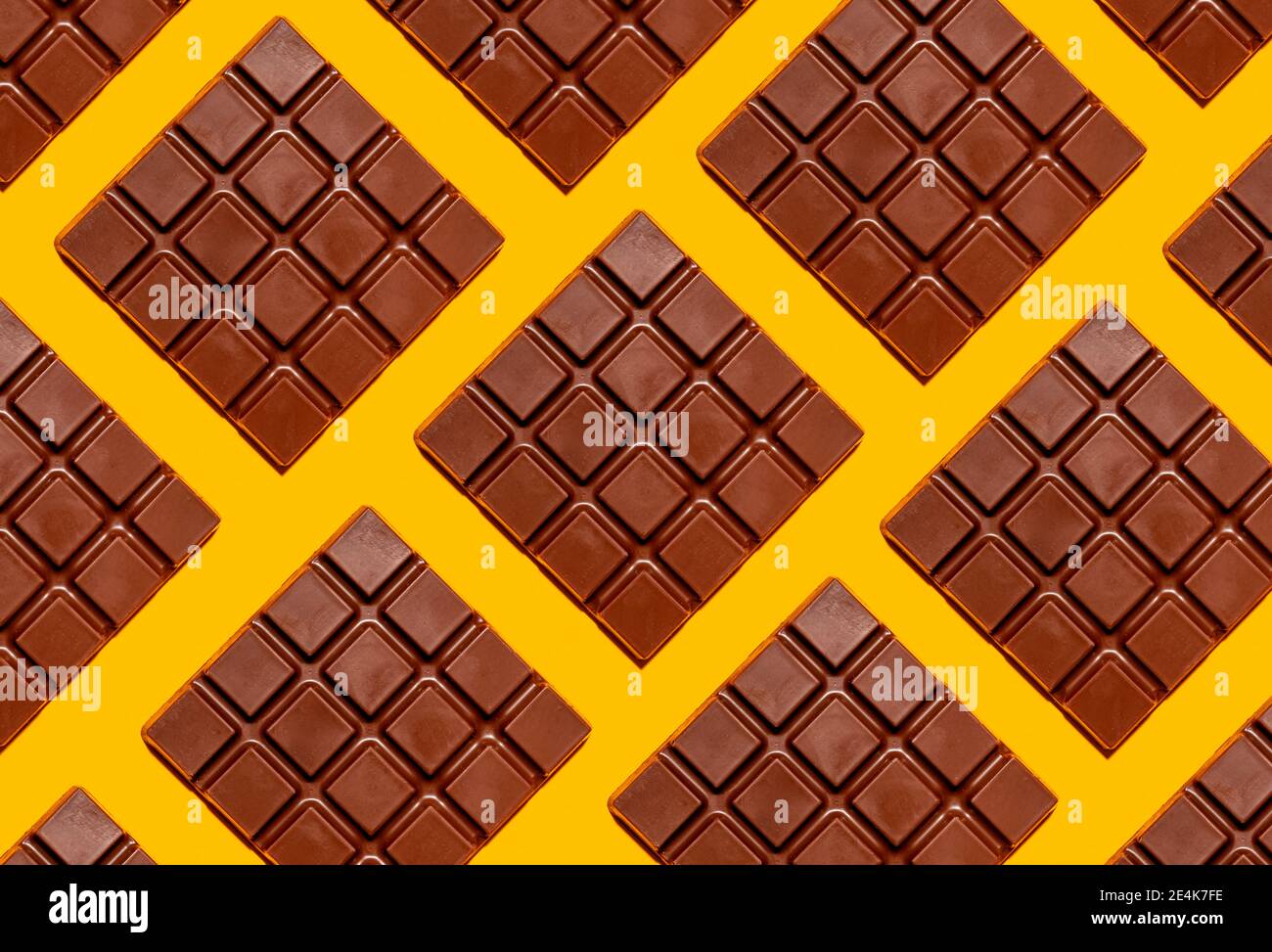 Pattern of chocolate bars against yellow background Stock Photo - Alamy