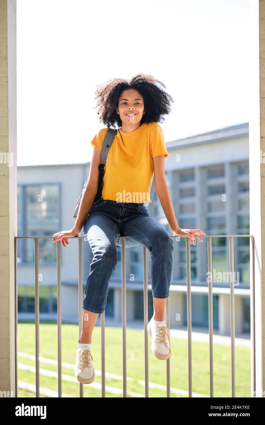 Woman sitting railing hi-res stock photography and images - Alamy