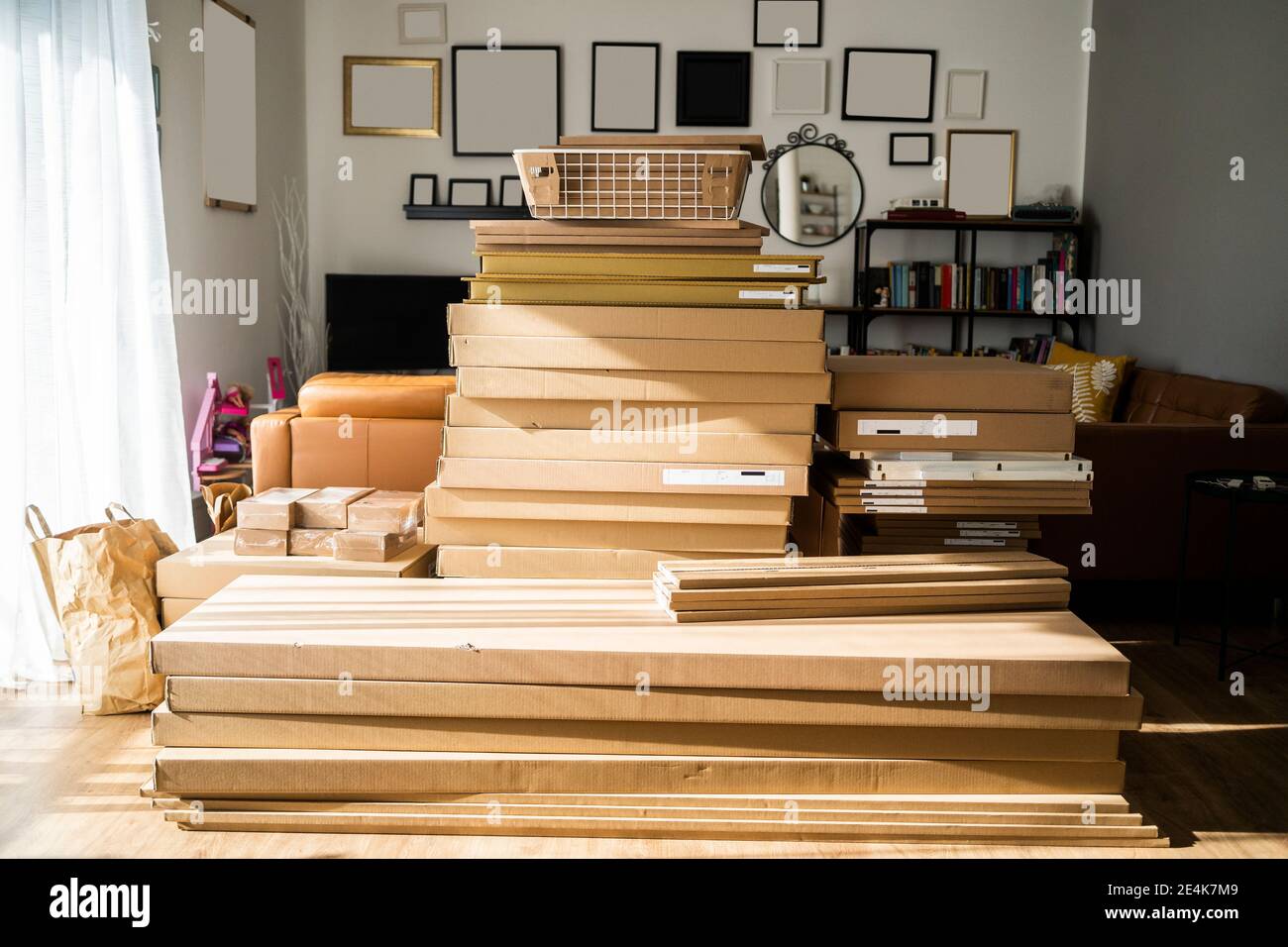 Waste cardboard boxes stack in living room Stock Photo - Alamy