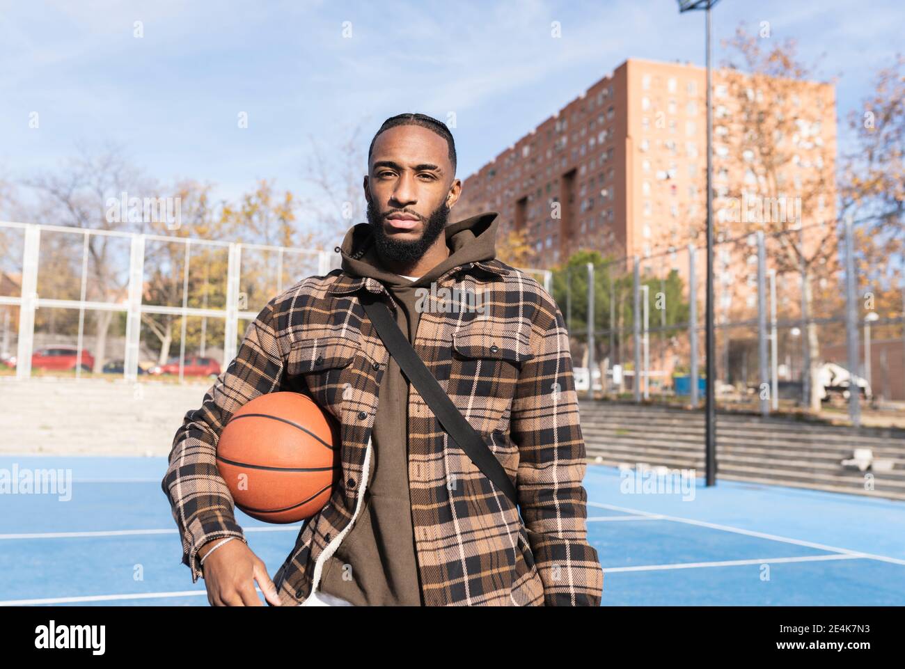 Young man holding basketball court hi-res stock photography and images ...