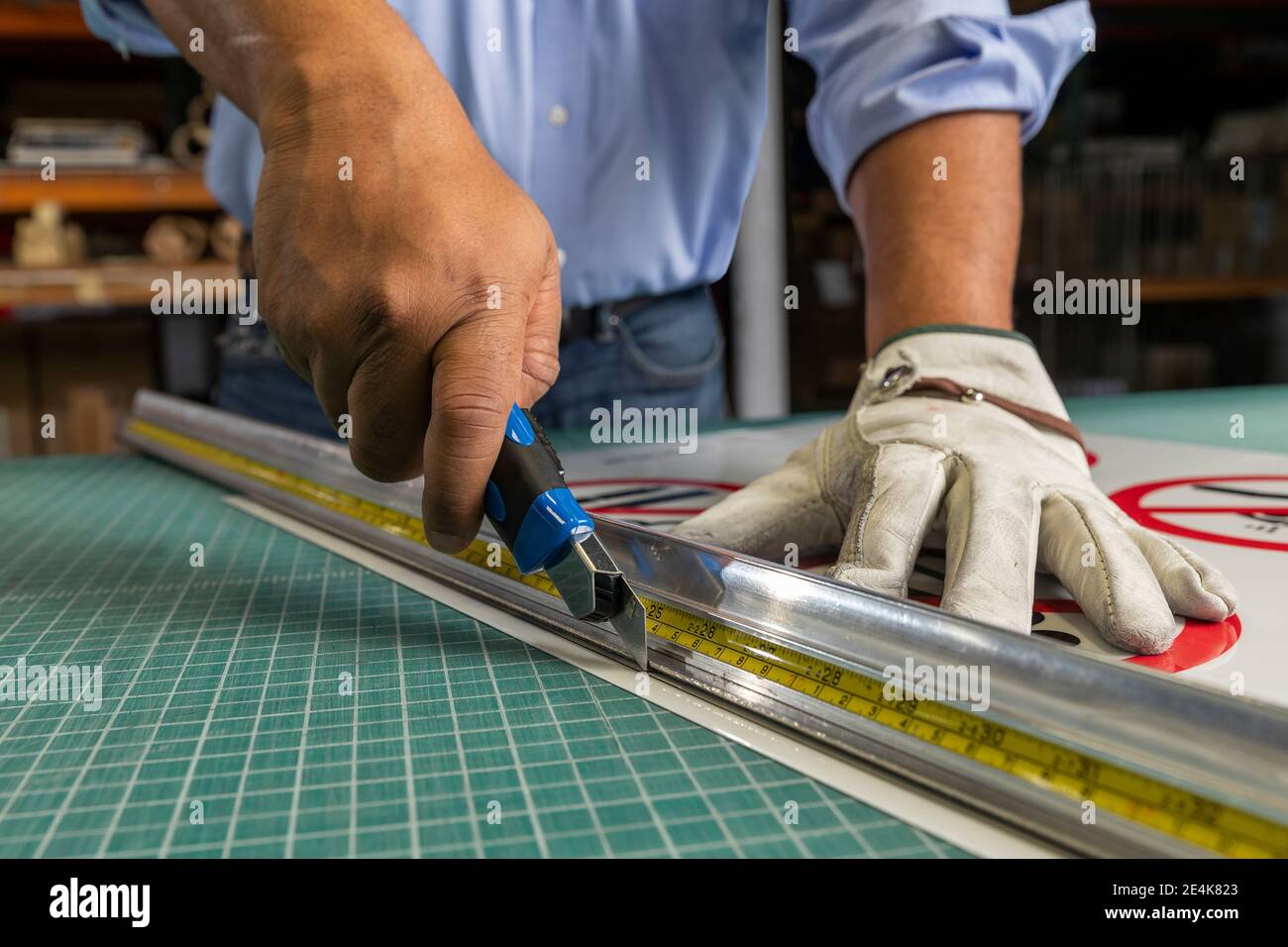 Supervisor cutting sign paper edges with equipment in print shop Stock ...