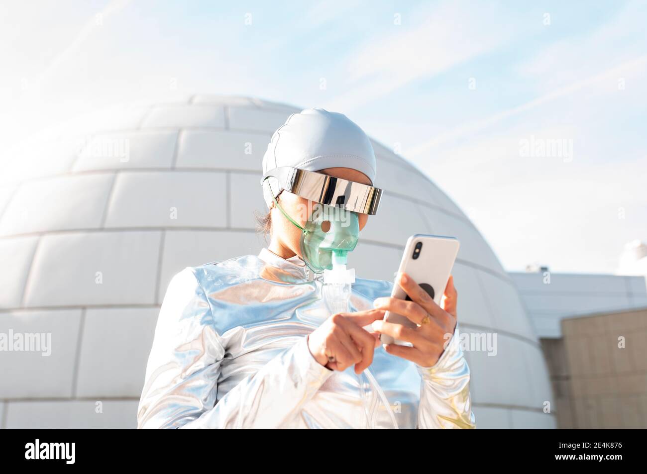 Explorer in shiny spacesuit wearing futuristic sunglasses and oxygen ...