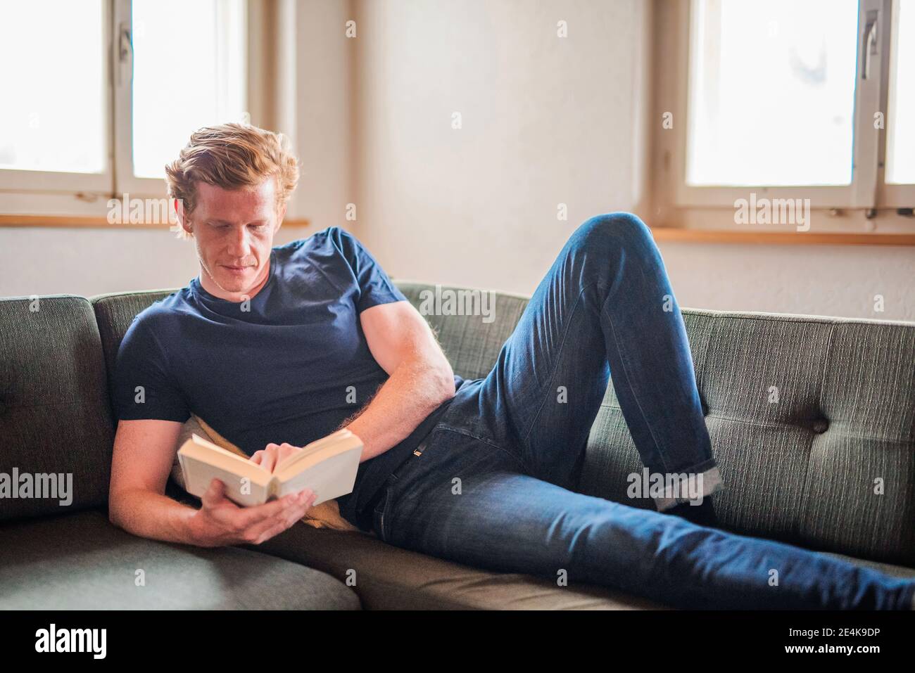 Man lying down on couch hi-res stock photography and images - Alamy