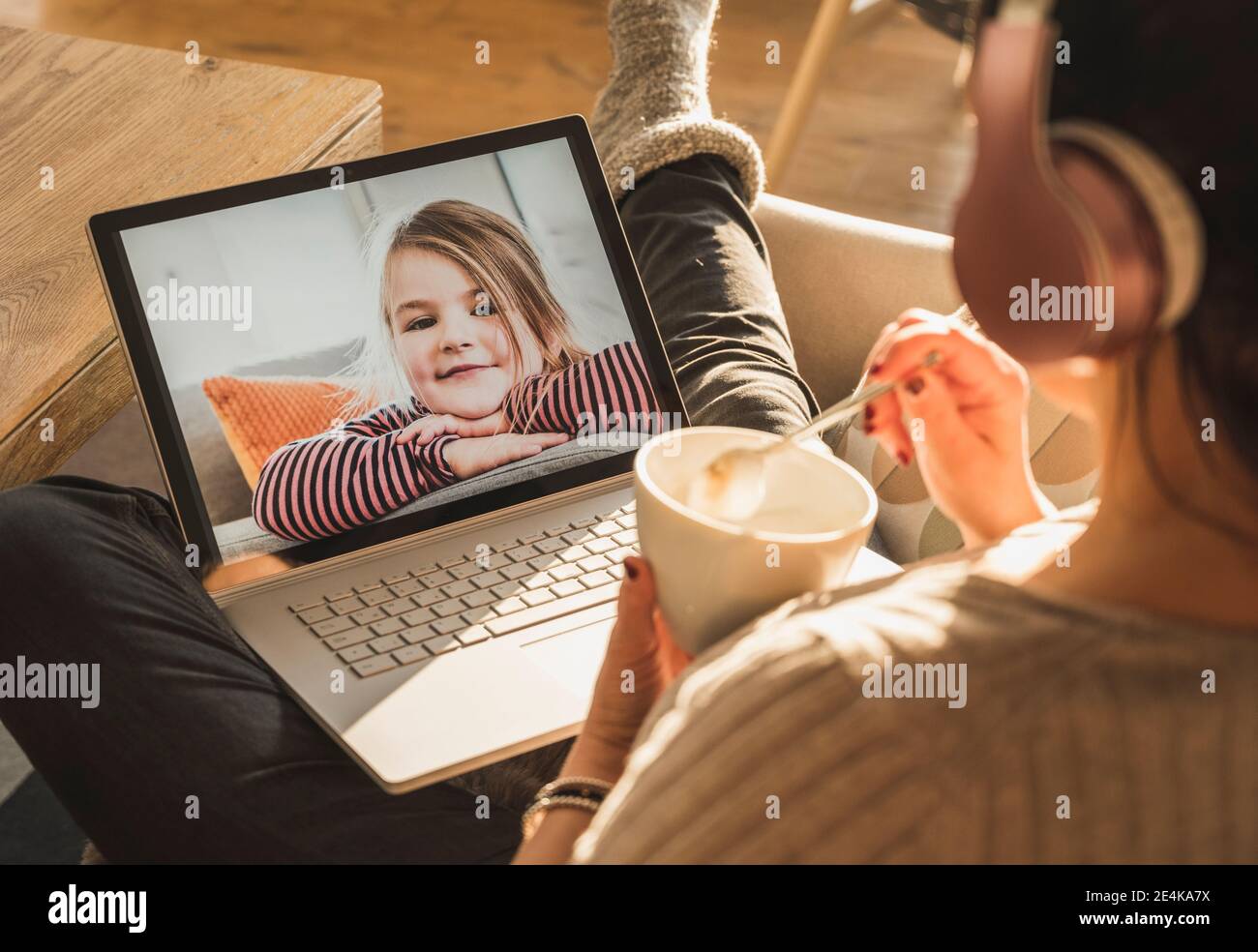 Little girl smiling on laptop screen during video call Stock Photo - Alamy